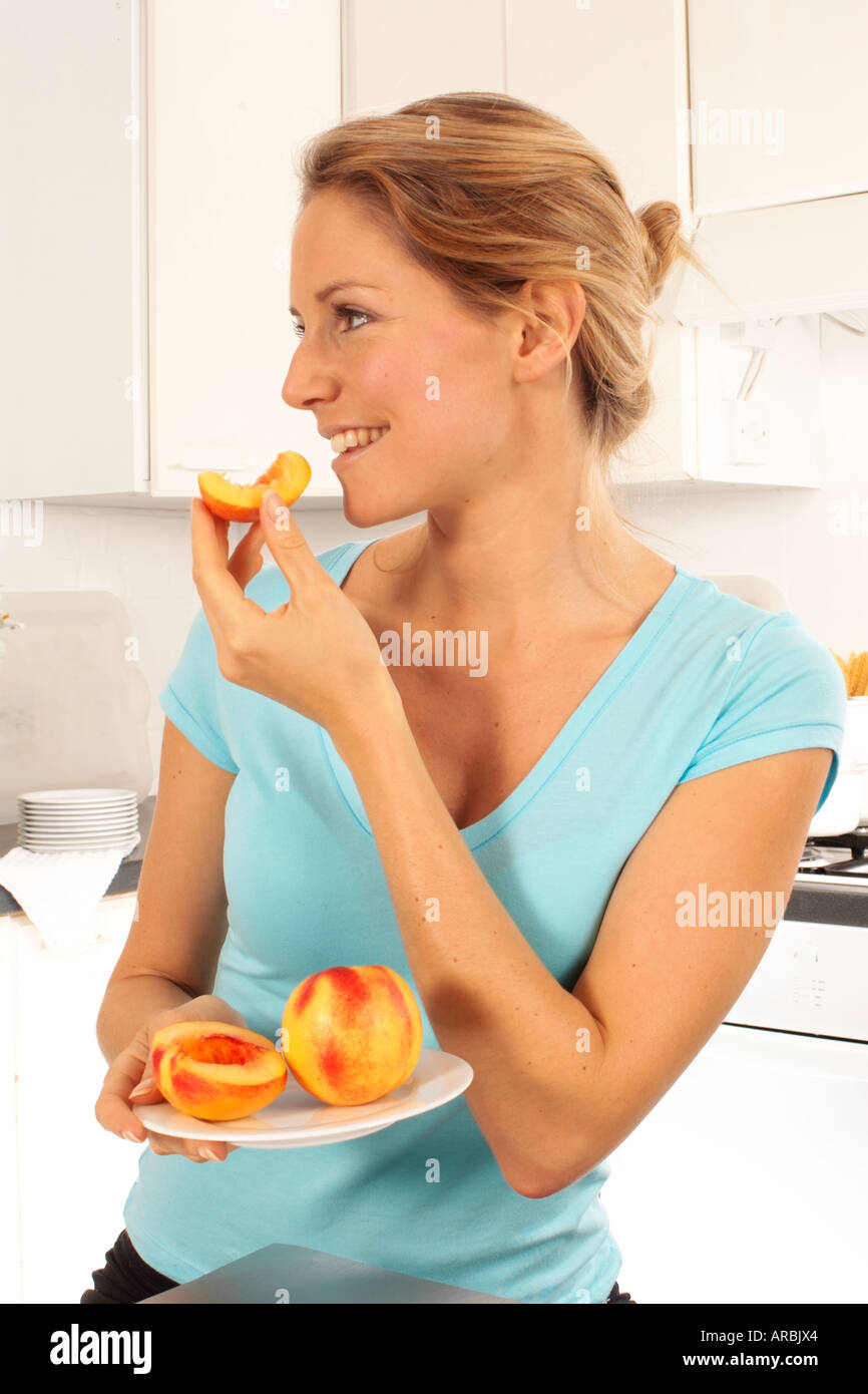 Woman eating nectarine hi-res stock photography and images - Alamy