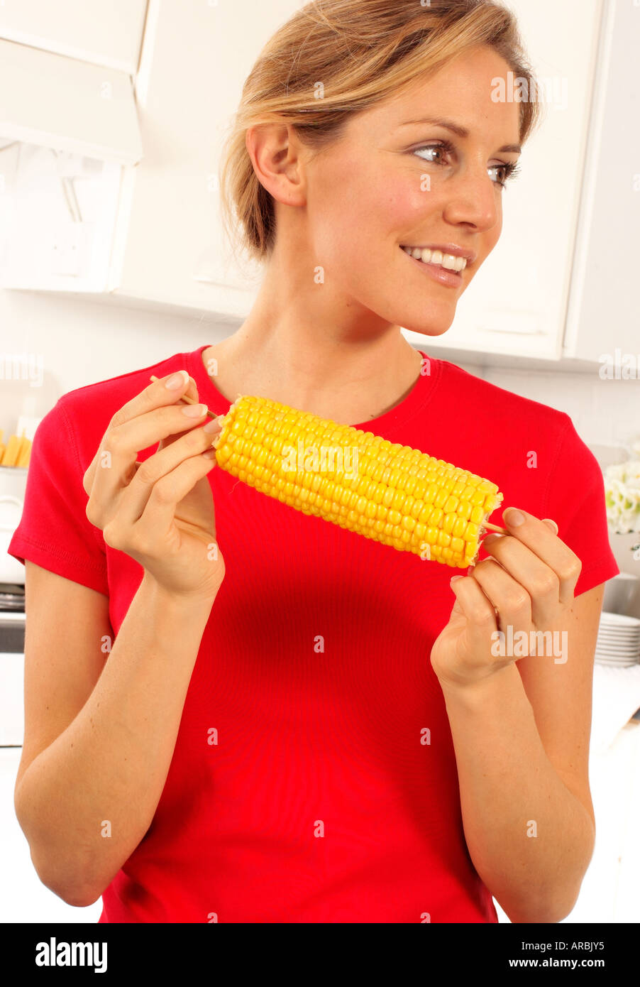 GIRL EATING SWEETCORN Stock Photo - Alamy