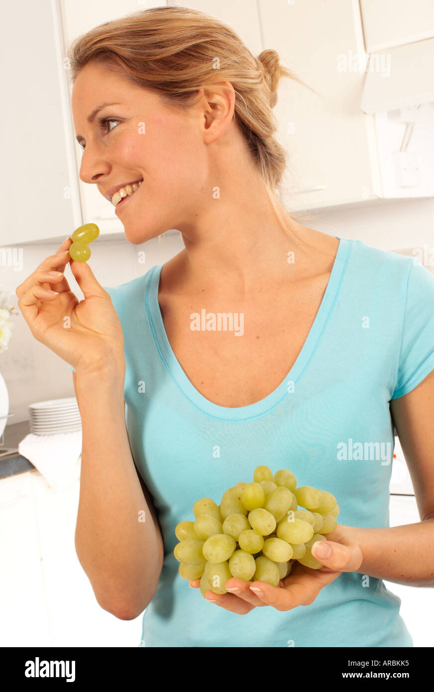 GIRL EATING GRAPES Stock Photo - Alamy