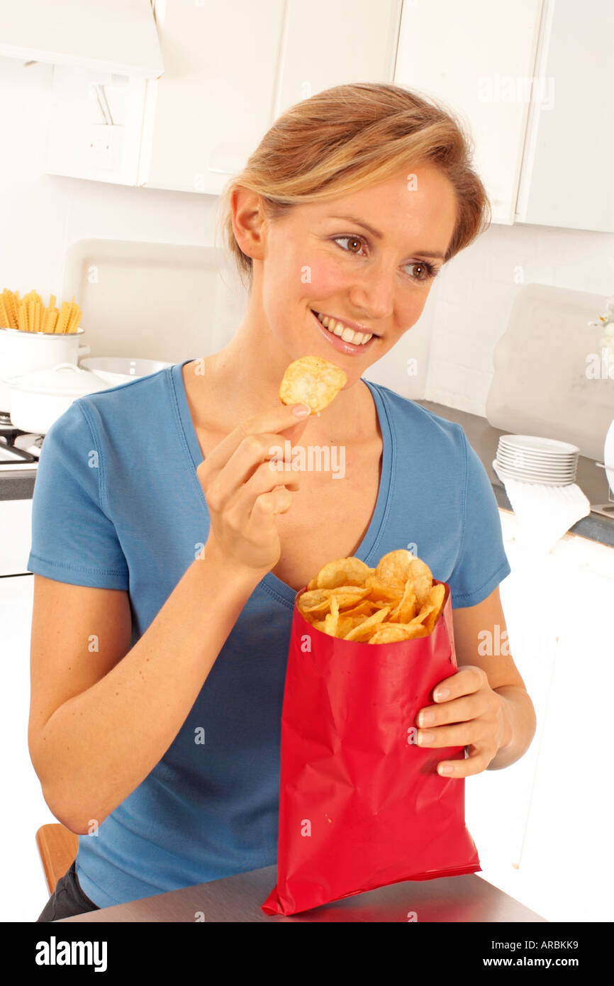 GIRL EATING POTATO CHIPS OR CRISPS Stock Photo - Alamy