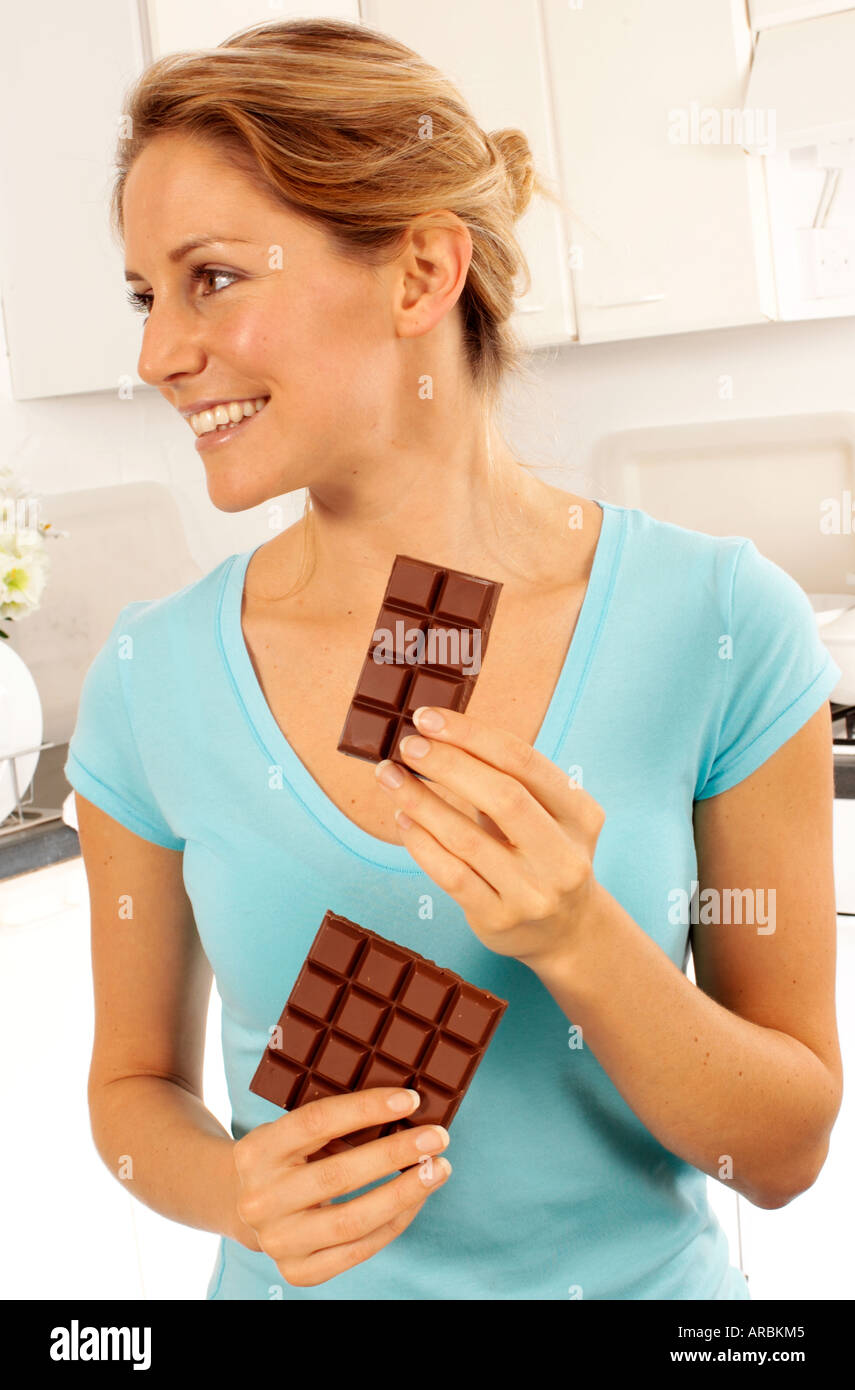 GIRL EATING BAR OF CHOCOLATE Stock Photo - Alamy