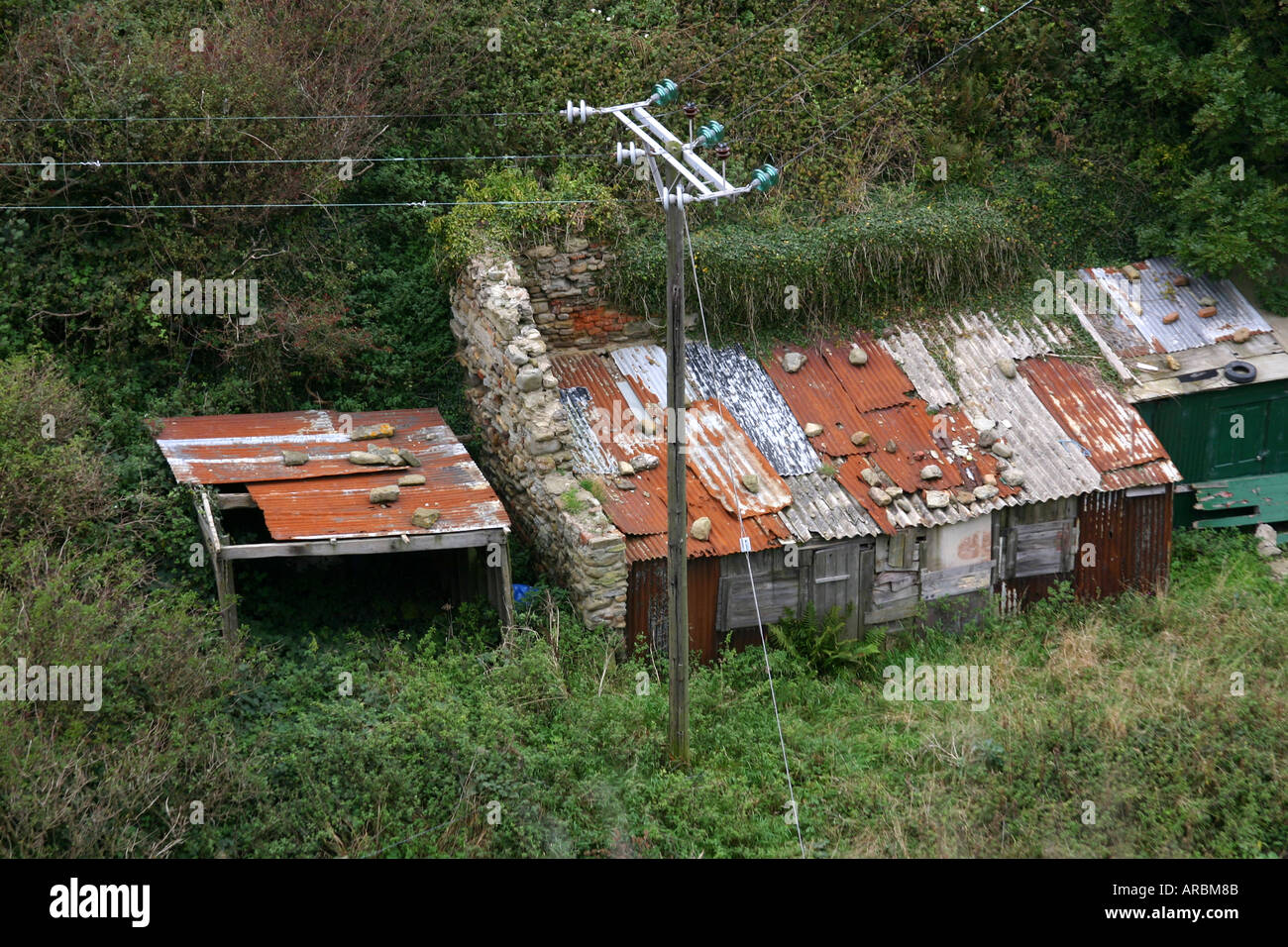 Old steel and iron shed in rusty and dilapidated state near Staithes in ...