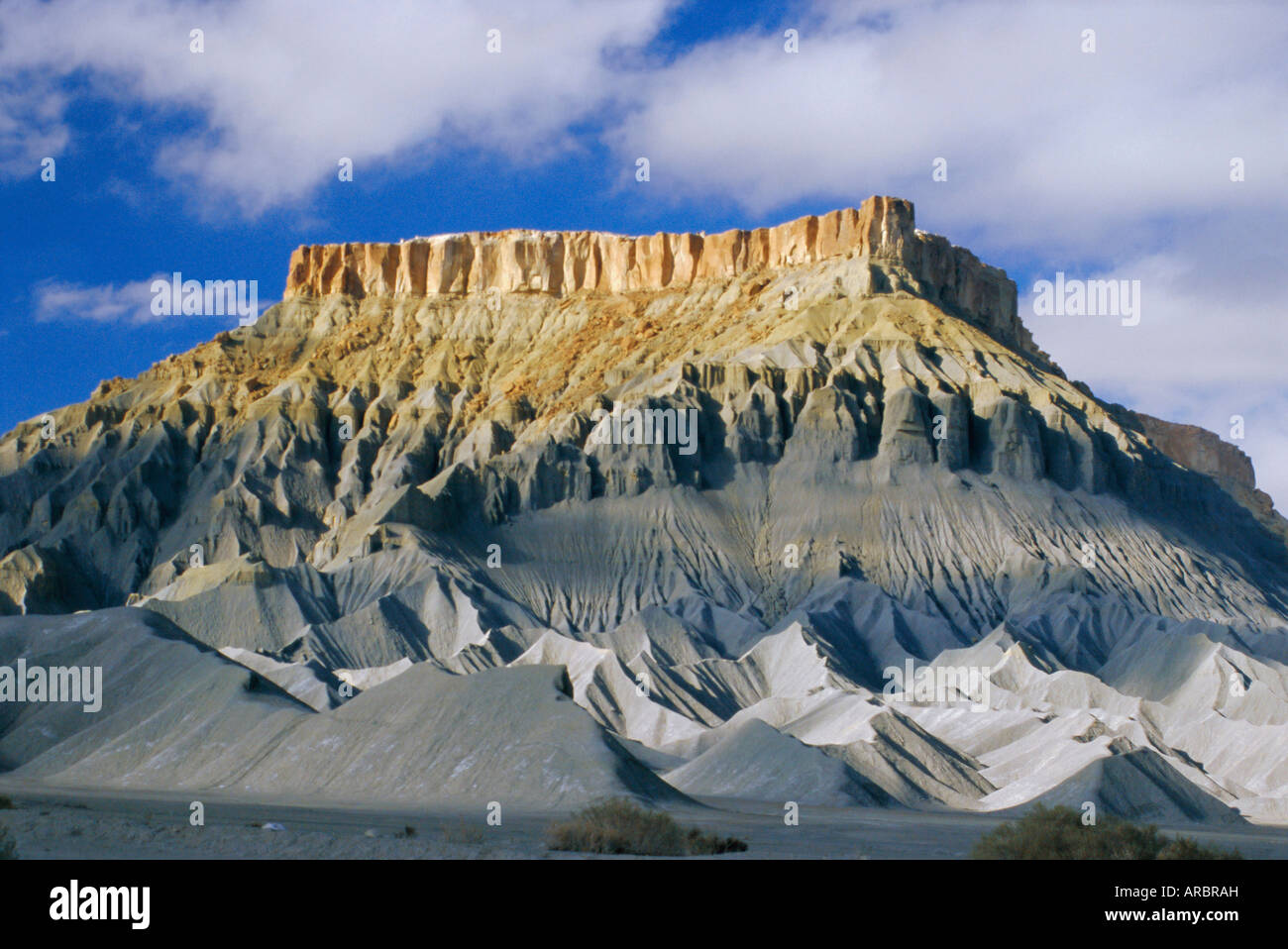 Mesaverde Sandstone cliff over gullied slopes of grey Mancos Shale ...