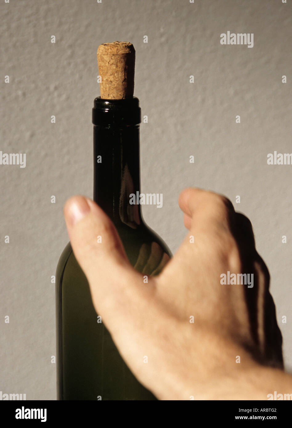 hand seizing a bottle of wine Stock Photo - Alamy