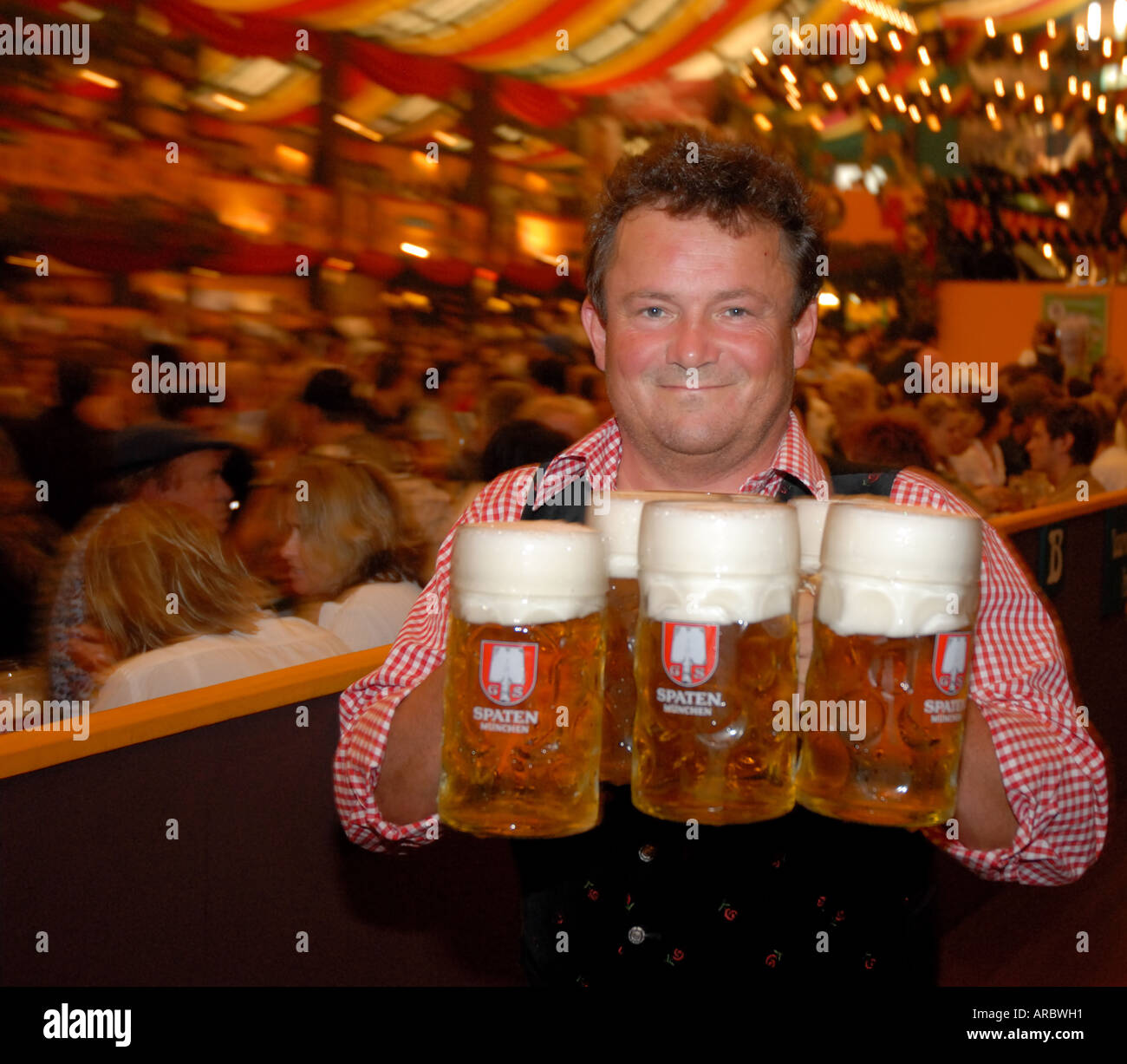 Oktoberfest waiter carrying beers Stock Photo - Alamy