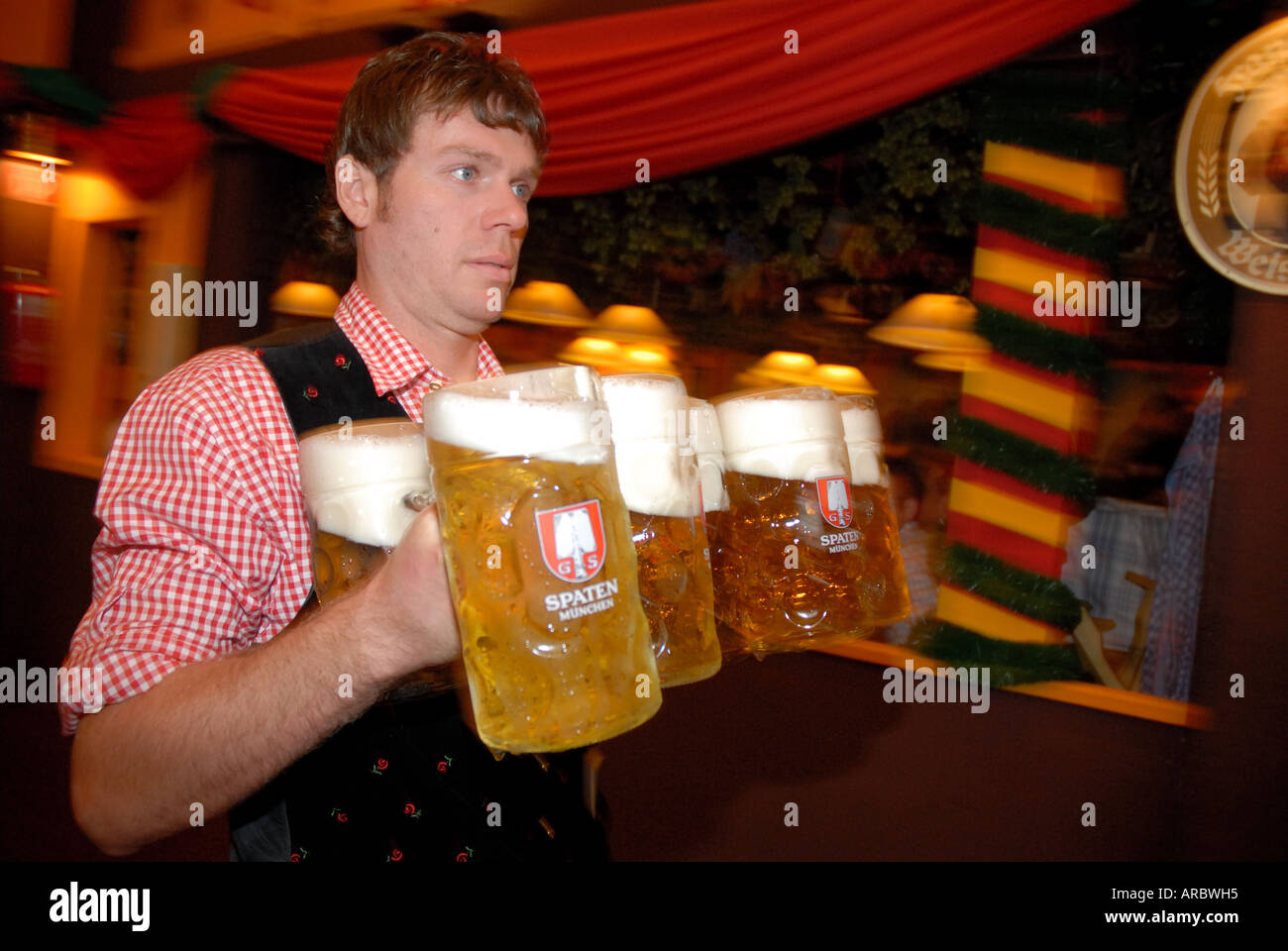Oktoberfest waiter carrying beers Stock Photo - Alamy