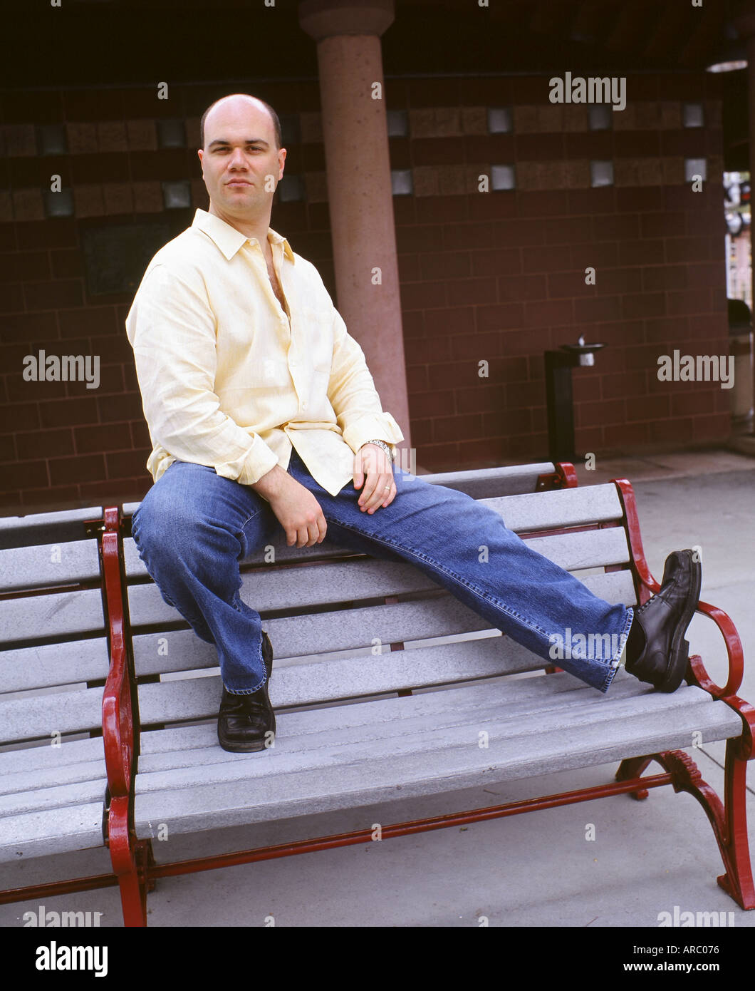 Funny man sitting on a park bench Stock Photo - Alamy
