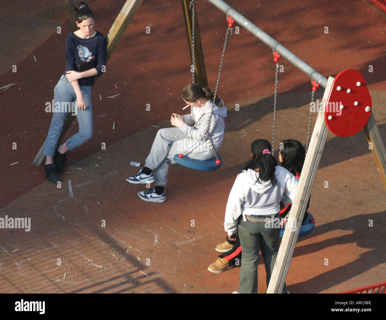 Teenagers hanging around on a south London playground Stock Photo - Alamy