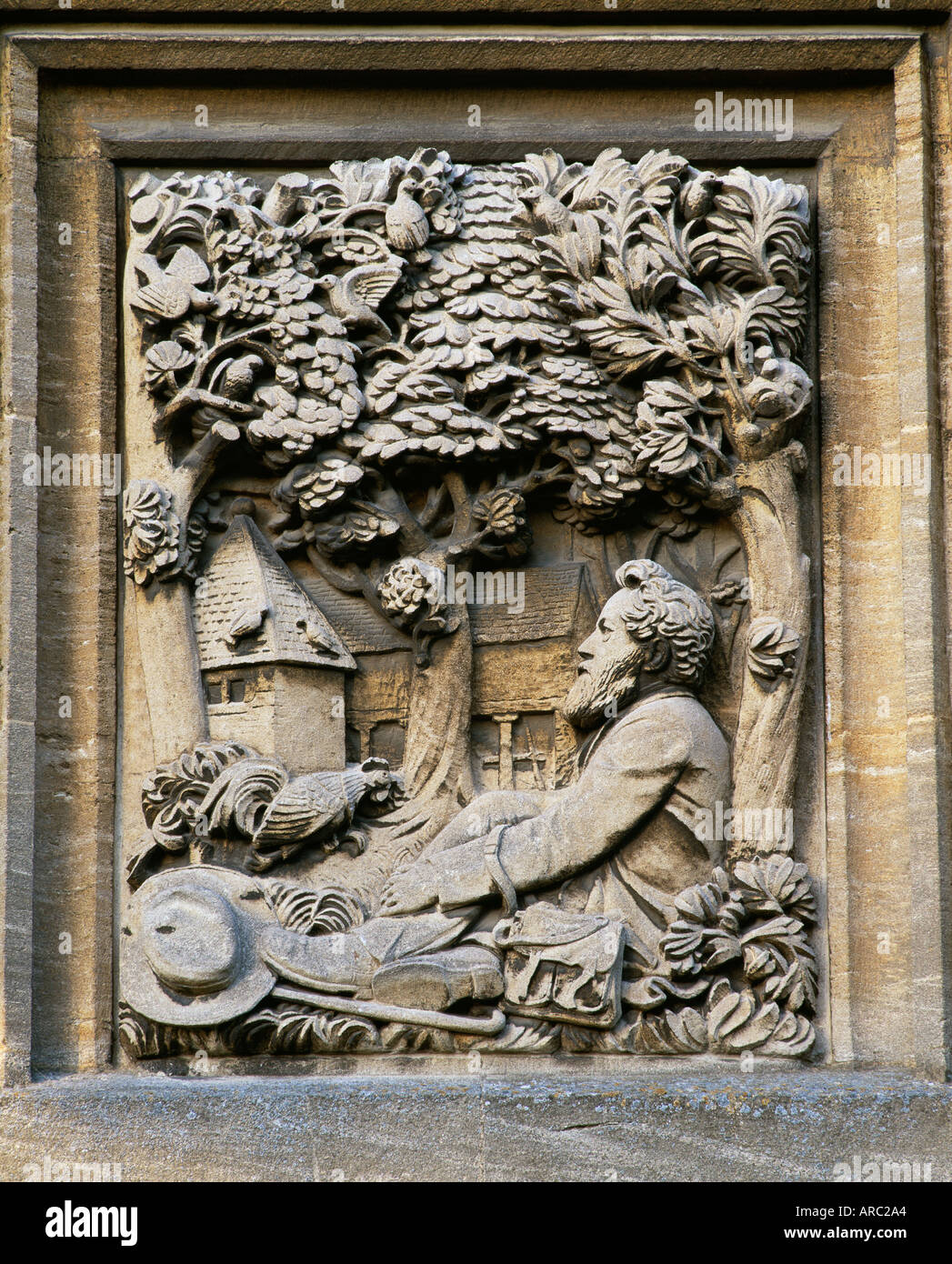 Stone bas relief of William Morris on a house wall in the village of ...