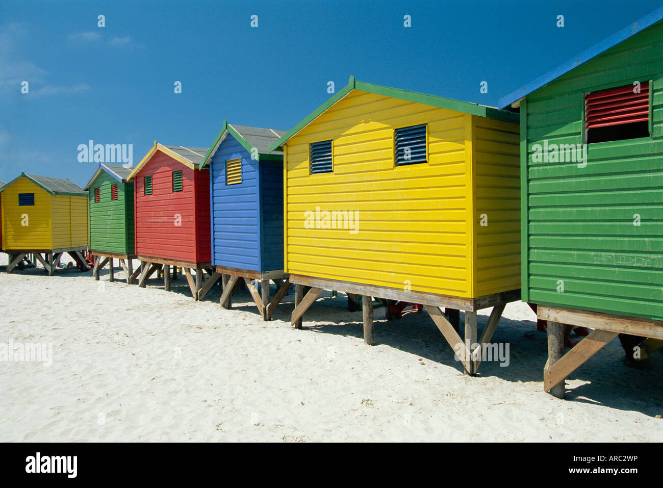 Brightly painted beach bathing huts at False Bay, Muizenburg, Cape Town ...