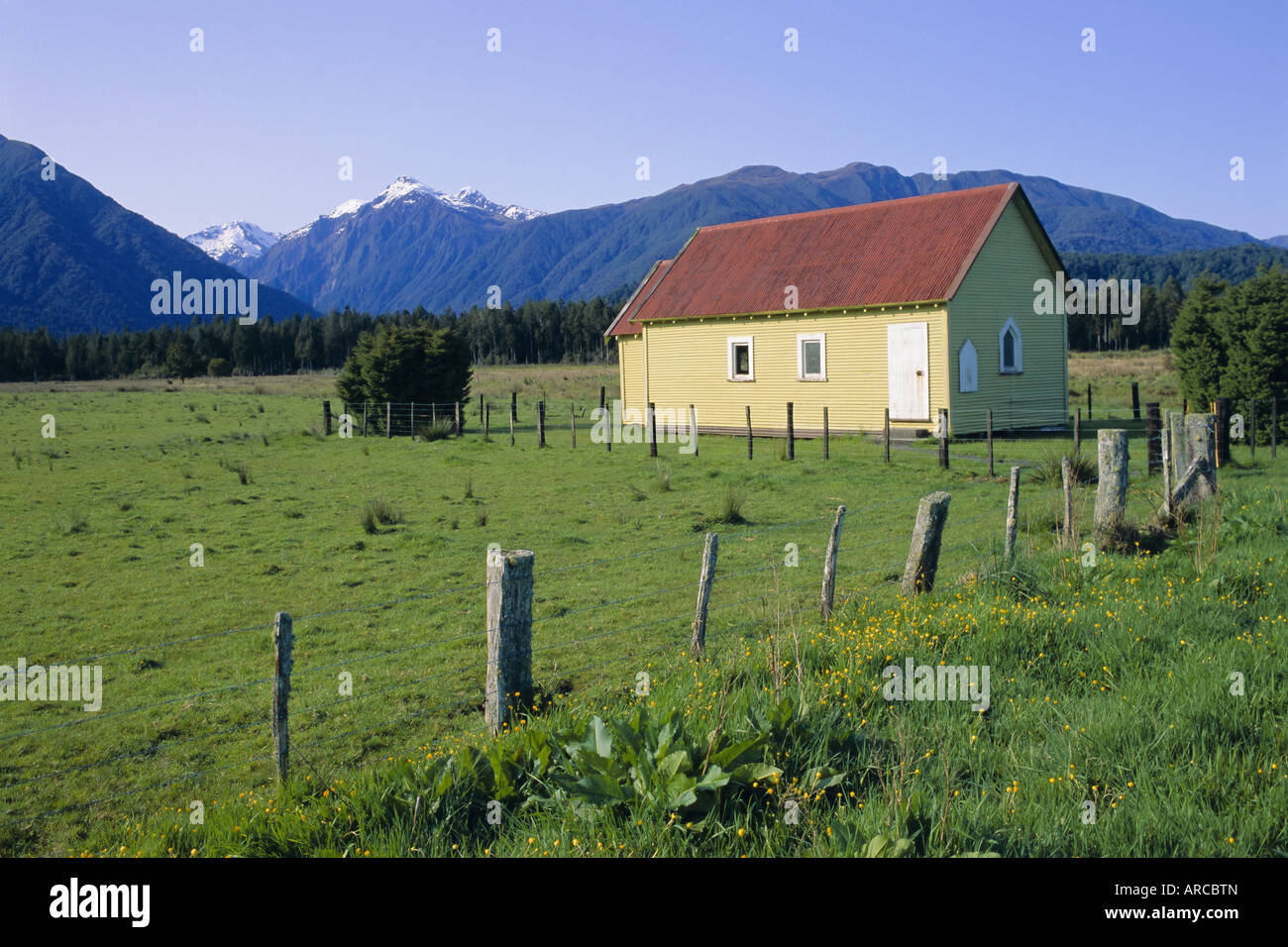 Field and colourful church at Jacobs River, South Island, New Zealand ...