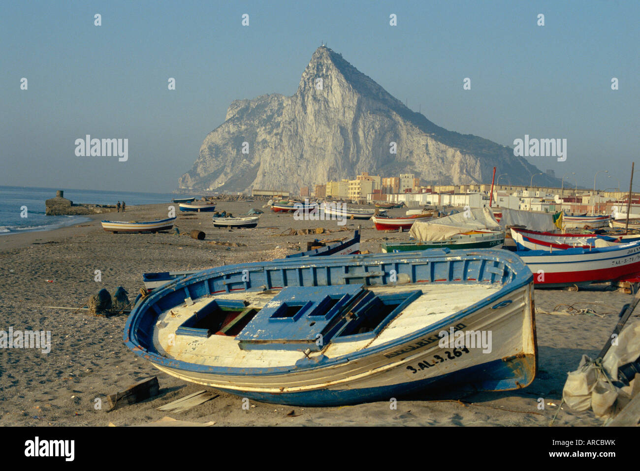 Boats pulled onto beach below the Rock of Gibraltar, Gibraltar Stock ...