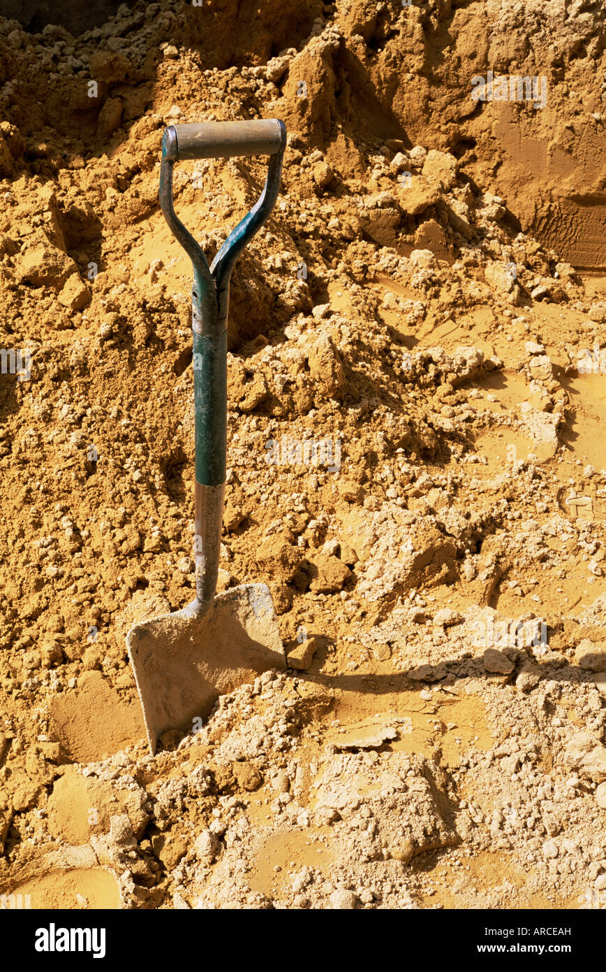 Close-up of spade in sand on a building site, City of London, England ...