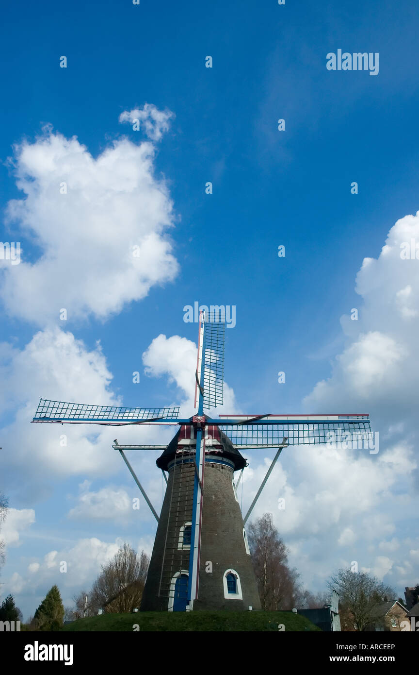 Windmill in a small dutch town under a blue sky Stock Photo - Alamy