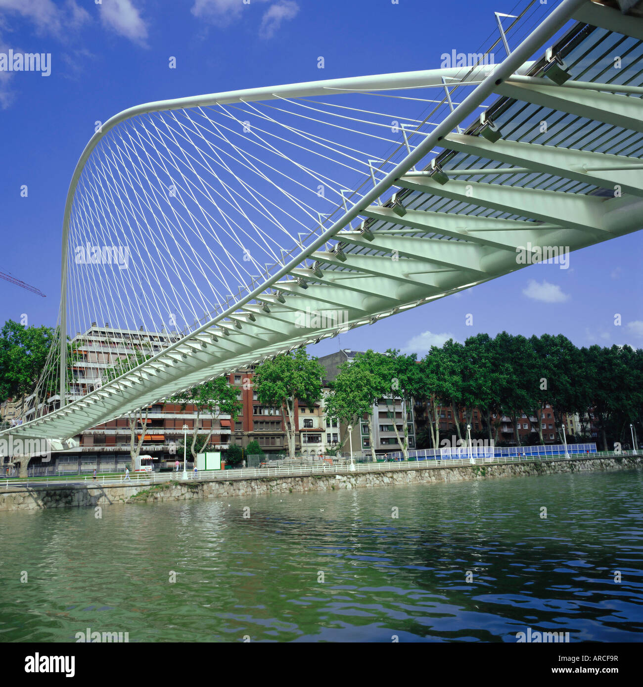 Zubizuri curved pedestrian bridge over Bilbao River, Bilbao, Pais Vasco ...