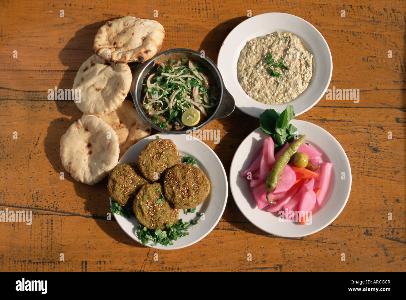 Plates of traditional food, falafel, babaghanoush and shawarma, with ...