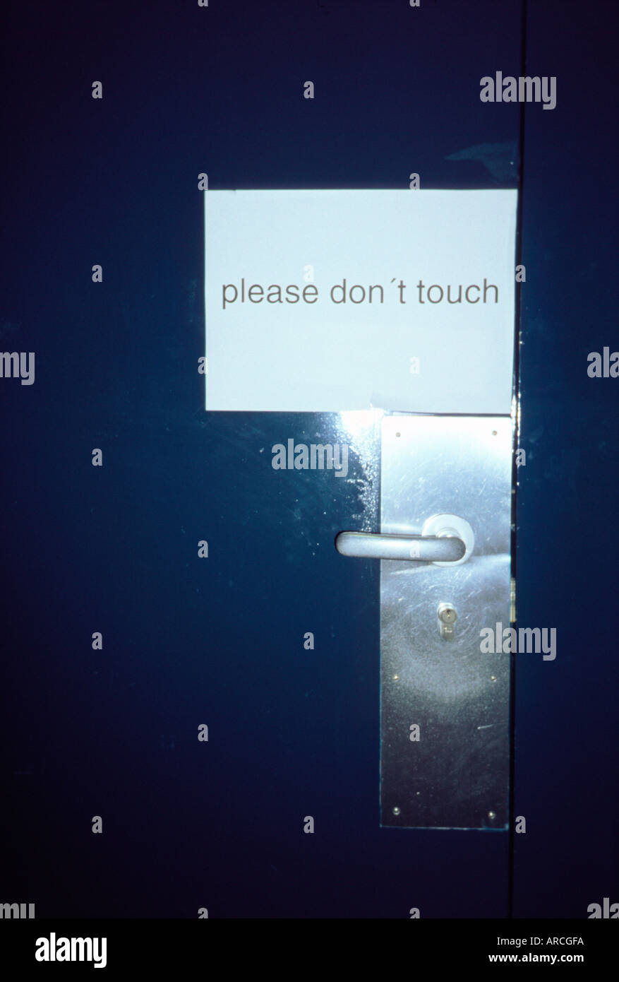 A sign over a door handle reading please don t touch Stock Photo - Alamy