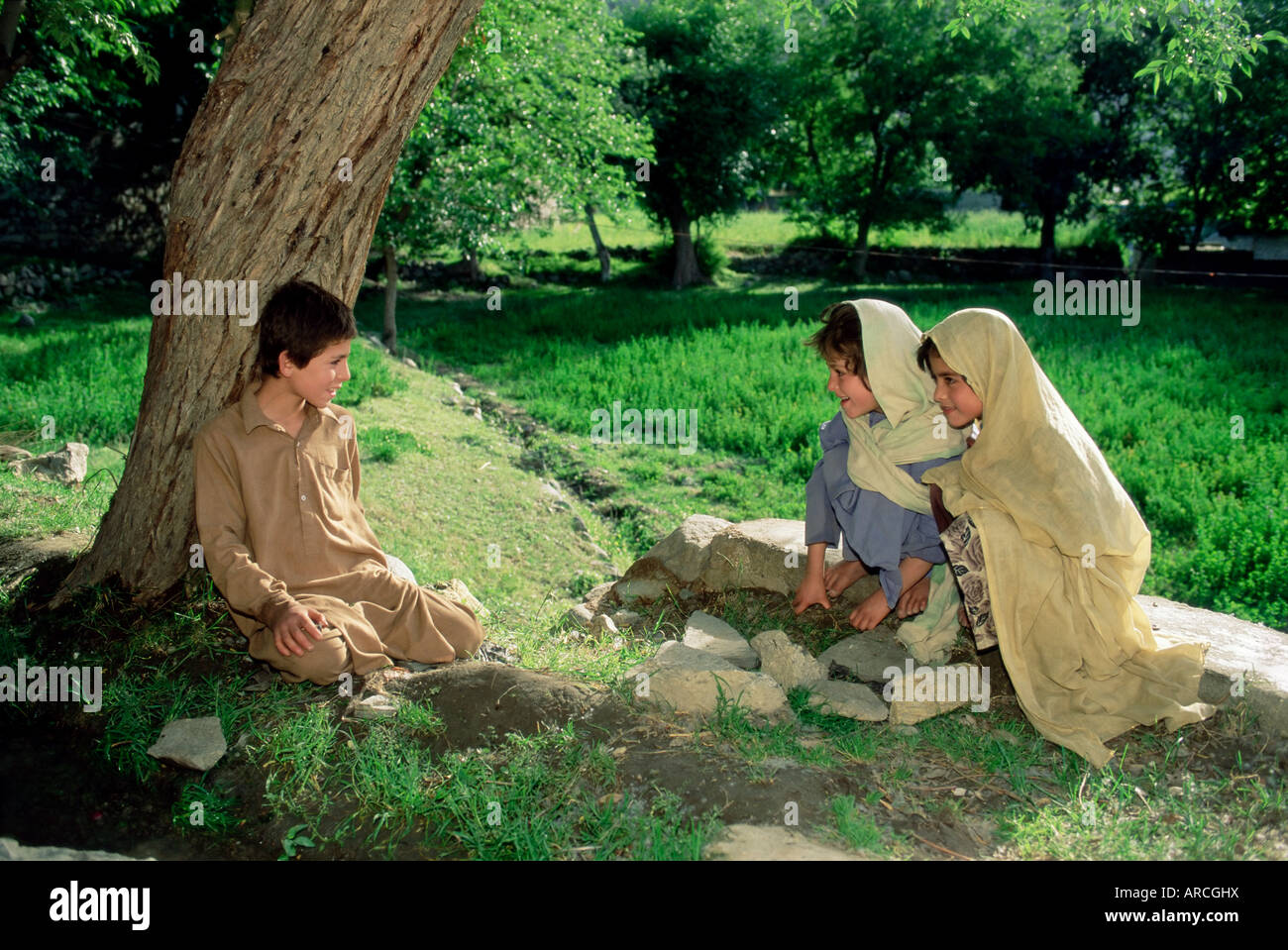 Children chatting under a tree, Gilgit, Pakistan, Asia Stock Photo - Alamy