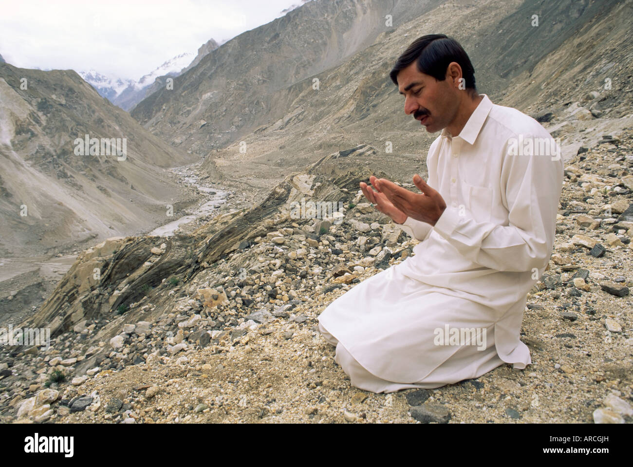 Muslim driver praying, Karakorum Highway, north of Karimabad, Hunza ...