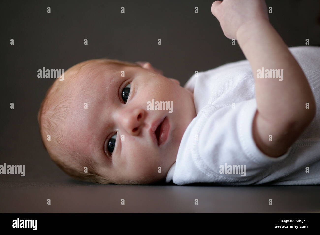 Baby lying on back Stock Photo - Alamy