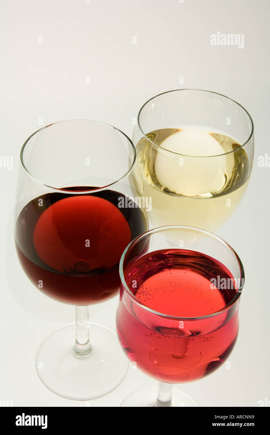 A glass each of red, white and rose wine on a white background Stock ...