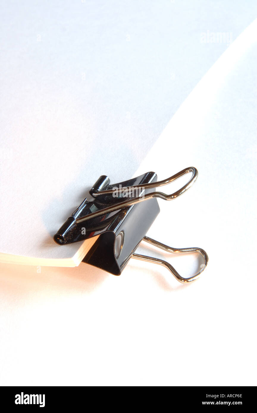 Black paperclip holds several sheets of white paper Stock Photo - Alamy