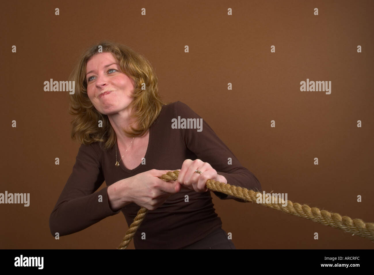 Young woman pulling on a rope Stock Photo - Alamy Young woman pulling on a rope Stock Photo - Alamy