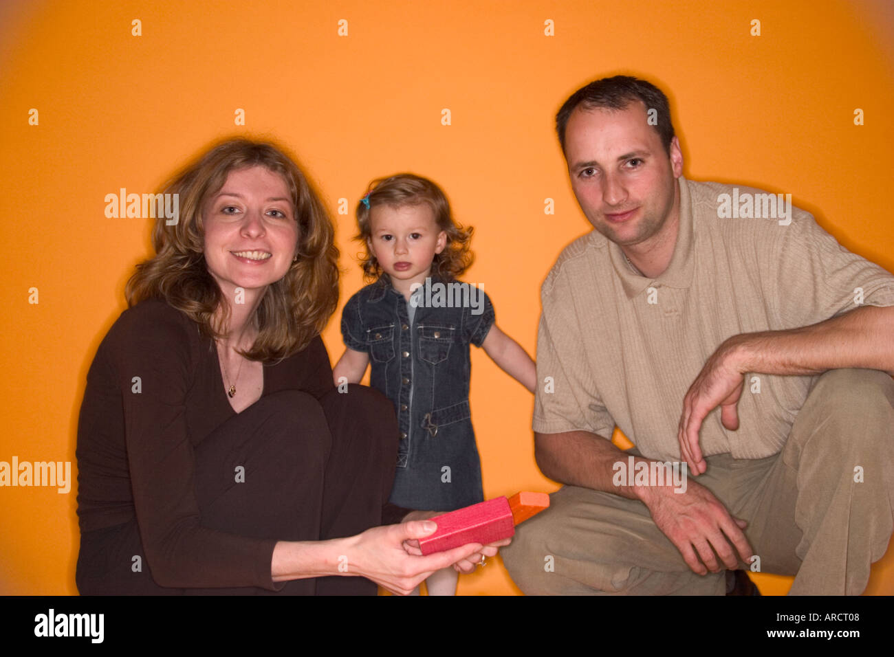Young girl posing with her parents Model Released Stock Photo - Alamy
