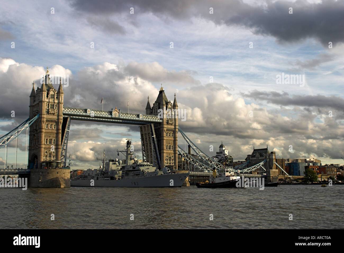 Tower Bridge, London with a Royal Navy Ship passinging underneath Stock ...