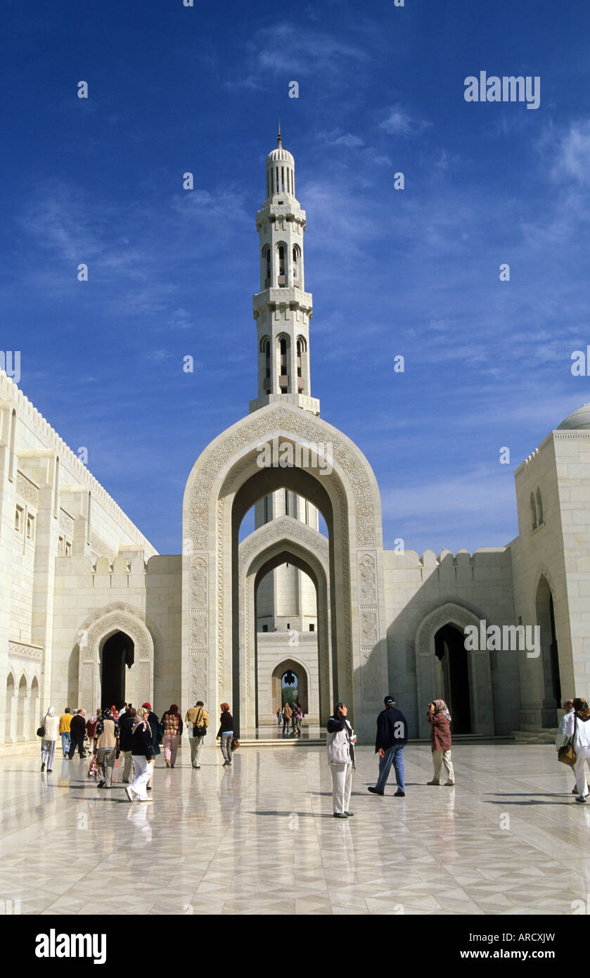 Carved stone arches and marble walkways, with one of the minarets ...