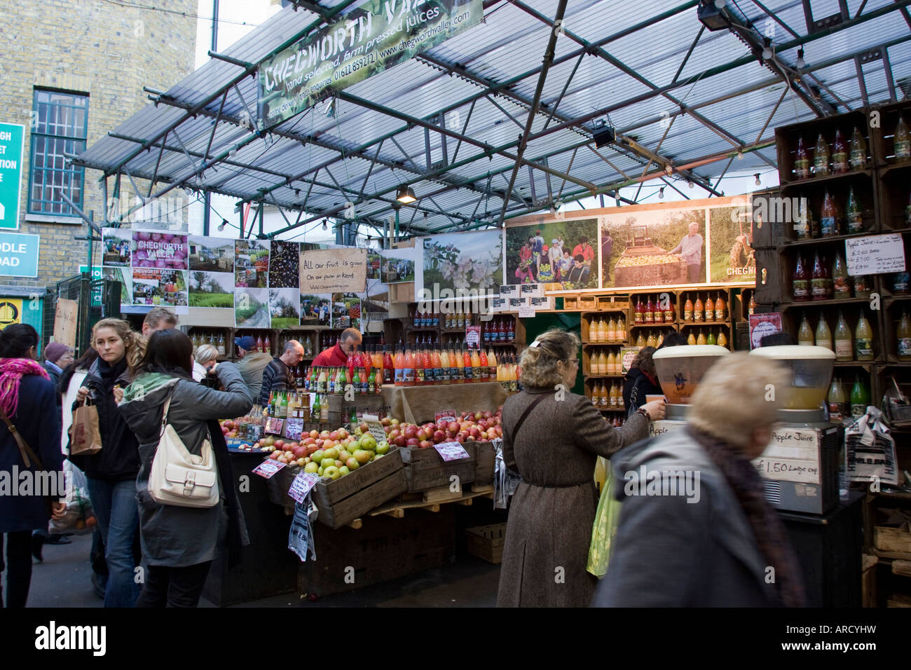 Customers at Stall selling fruit and juices at Borough Market Southwark ...