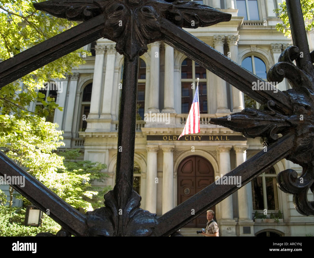 Looking through a black wrought iron gate to the Old City Hall, part of ...