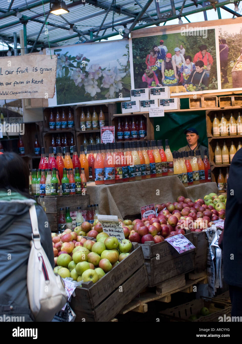 Customers at Stall selling fruit and juices at Borough Market Southwark ...