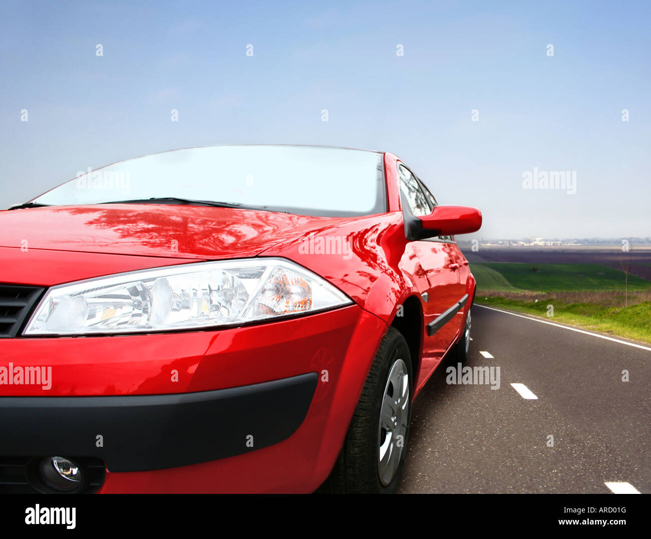 Beautiful red car on the road Stock Photo - Alamy