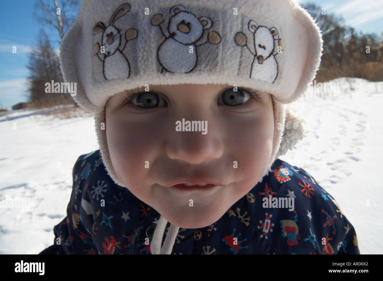 A child looking into camera interested smiling face very close Stock ...