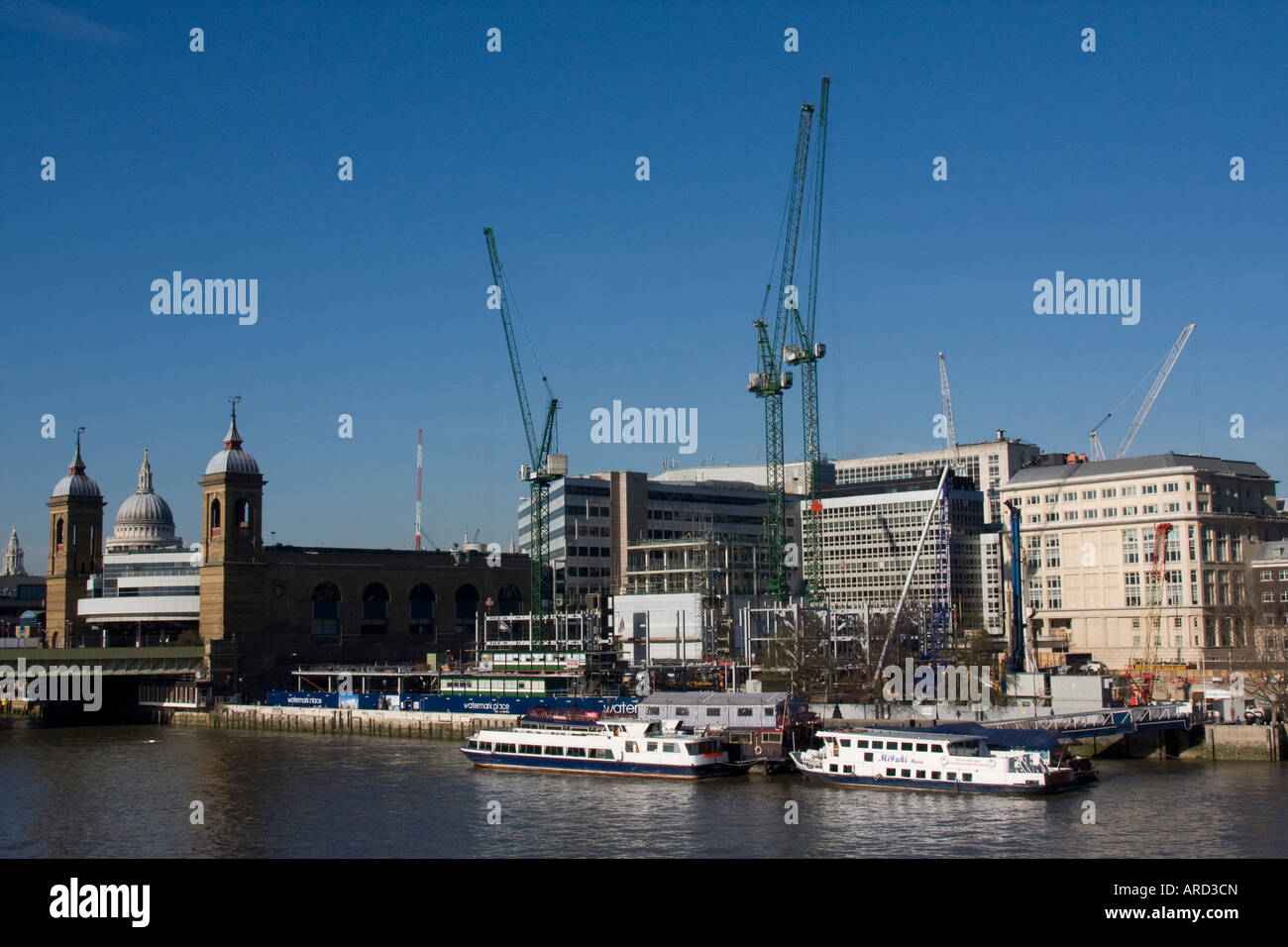 Tourist boat mooring next to building site on the River Thames City of ...