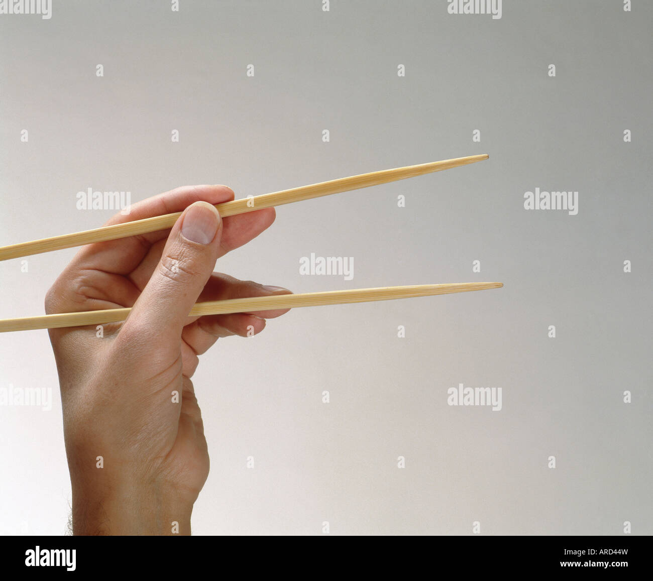 male hand holding chopsticks-side view Stock Photo - Alamy