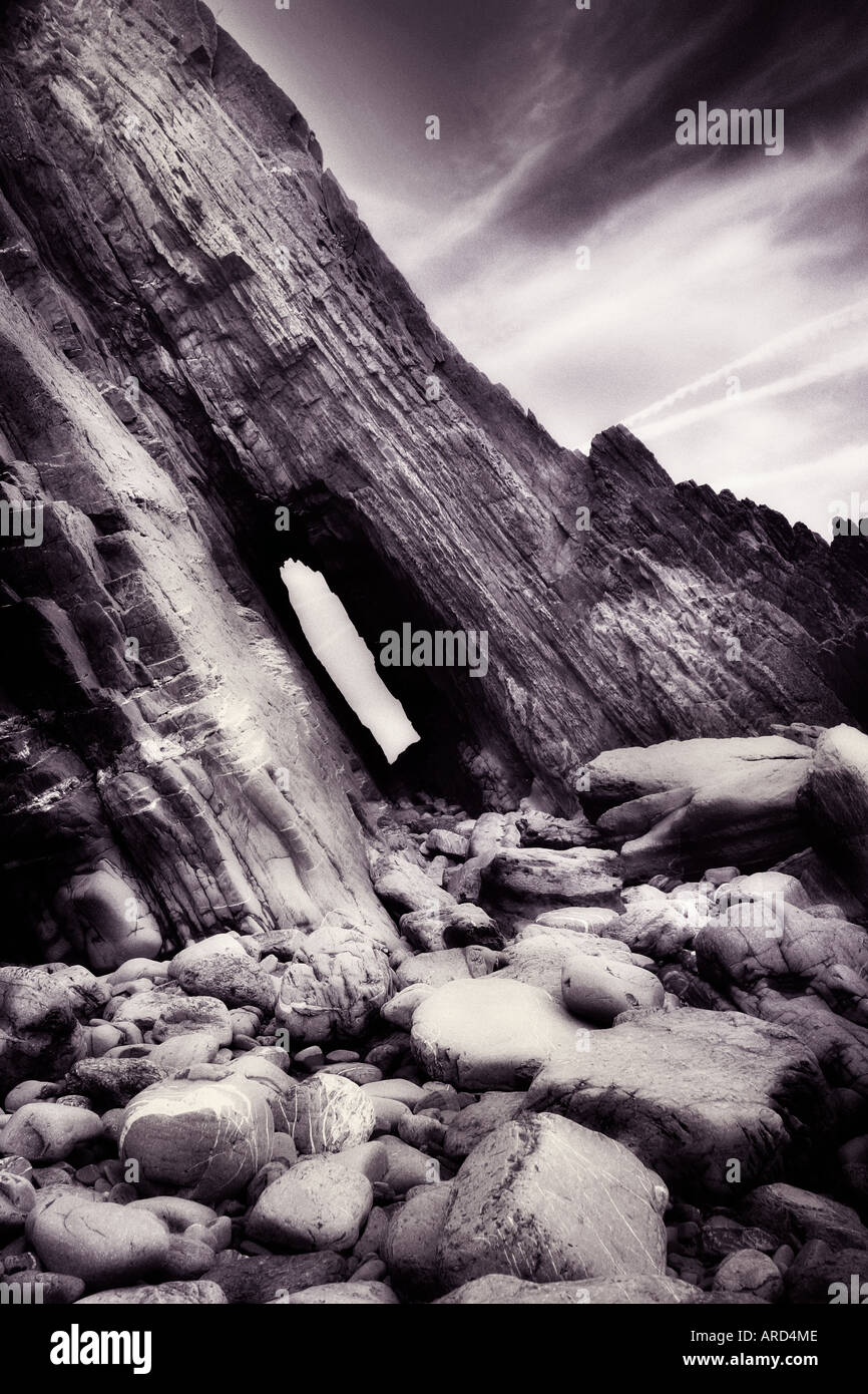 cave in the side of the cliff face Stock Photo - Alamy