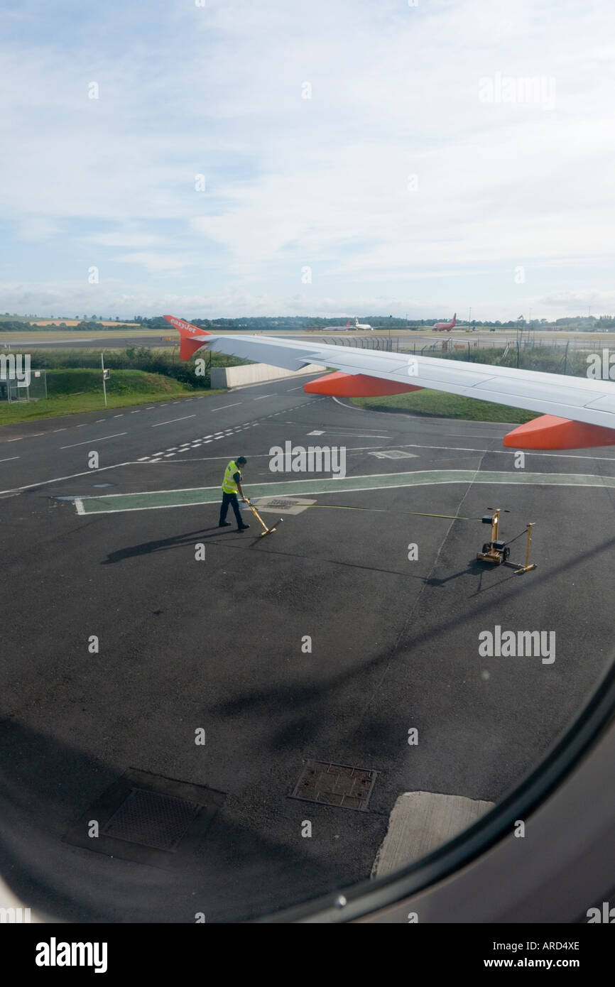 Aircraft window view moving a safety barrier Stock Photo - Alamy