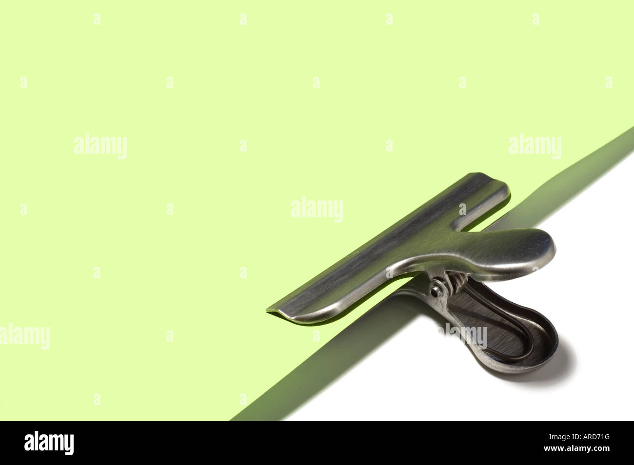 Metallic paperclip on green paper Use it on the bottom right corner of ...