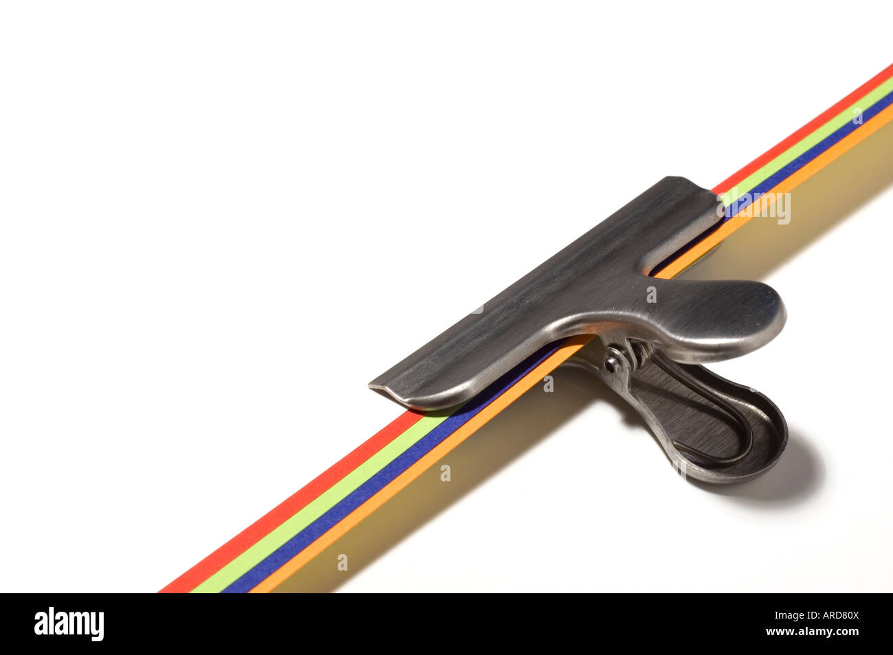 Metallic paperclip on multicolored paper Use it on the right bottom ...