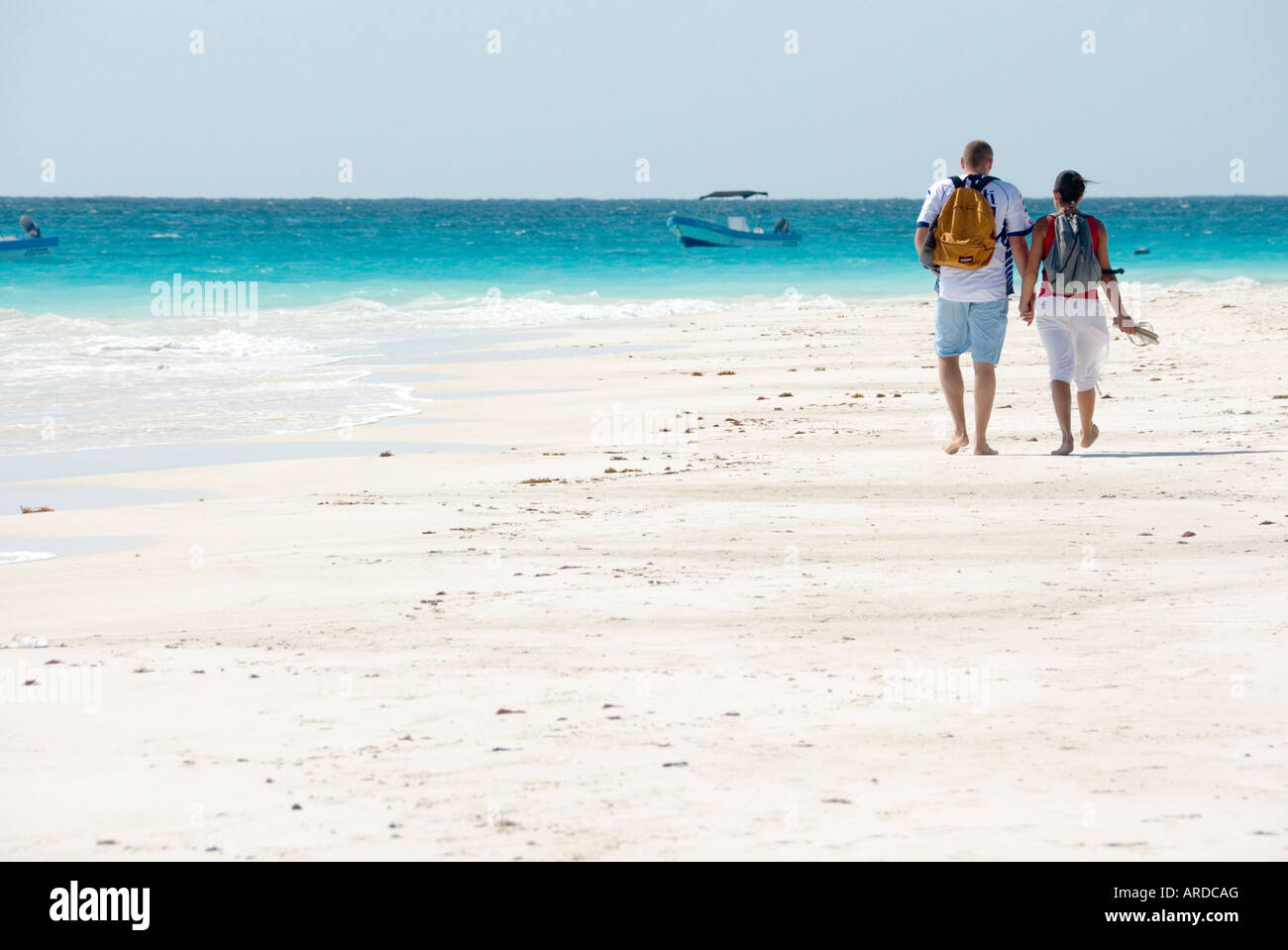 Rear View of Couple Holding Hands and Walking on White Sandy Caribbean ...