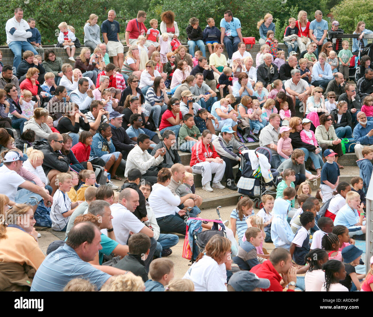 Crowd of people sitting at outdoor event Stock Photo - Alamy
