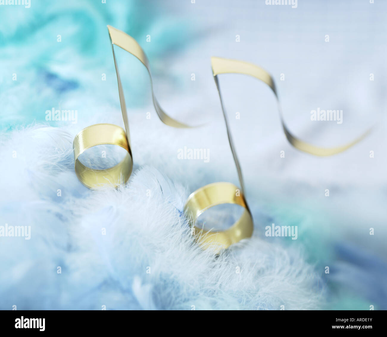 two golden quavers in blue feathers Stock Photo - Alamy