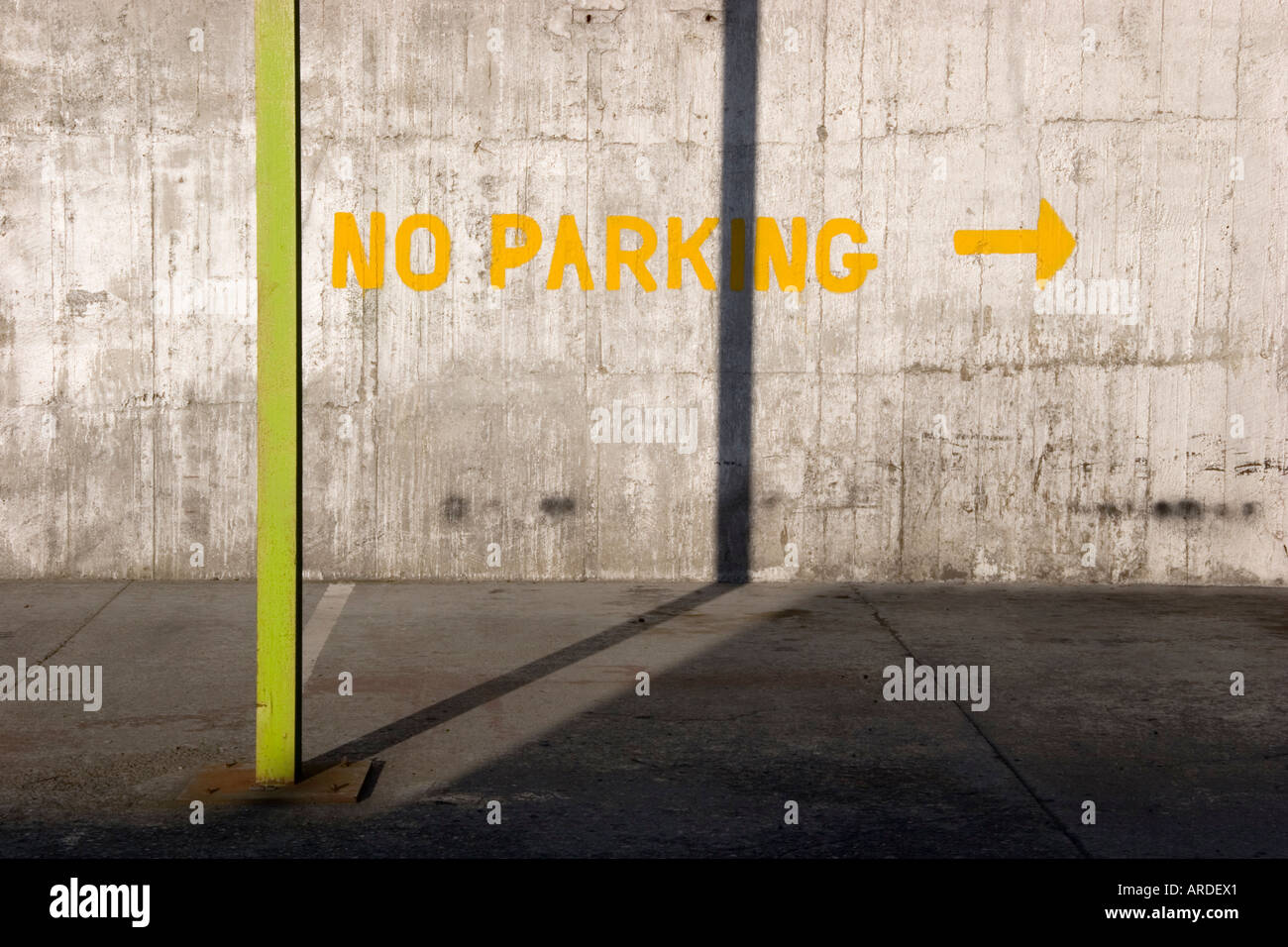 no parking sign on wall with post Stock Photo - Alamy
