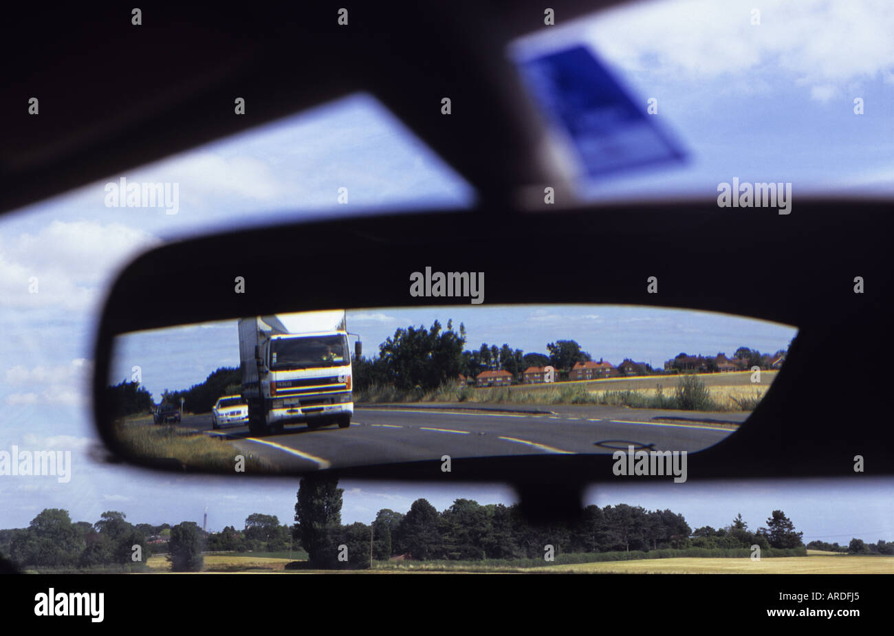 lorry travelling on dual carriageway reflected in vehicle rear view ...