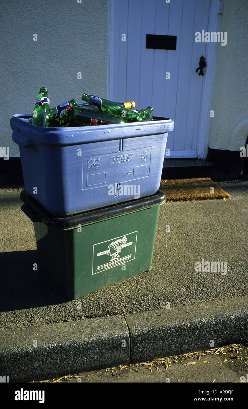 glass and paper waste recycling boxes awaiting collection on kerbside ...