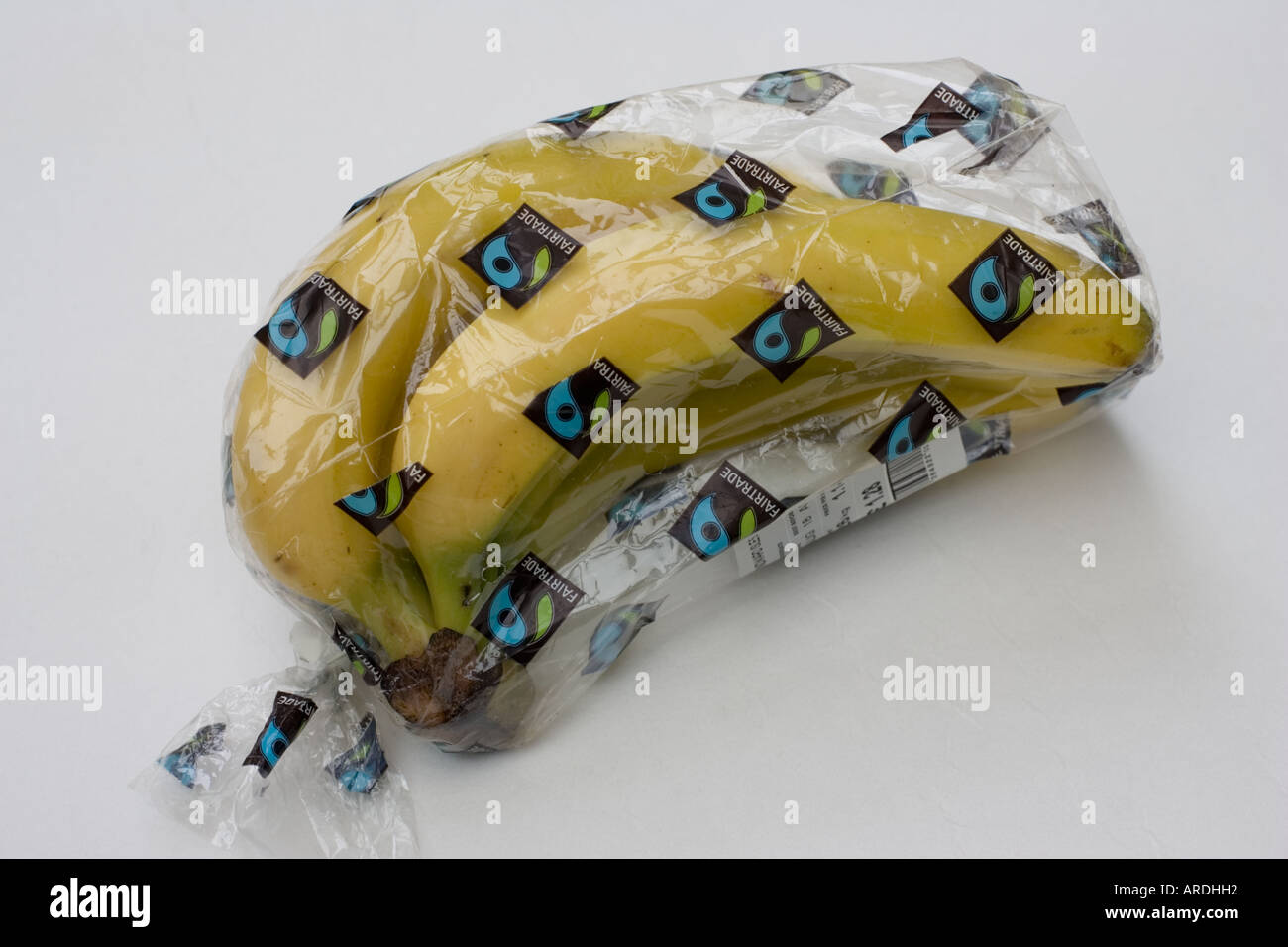Bunch of wrapped Fairtrade bananas from Tesco with FT logo on packaging ...