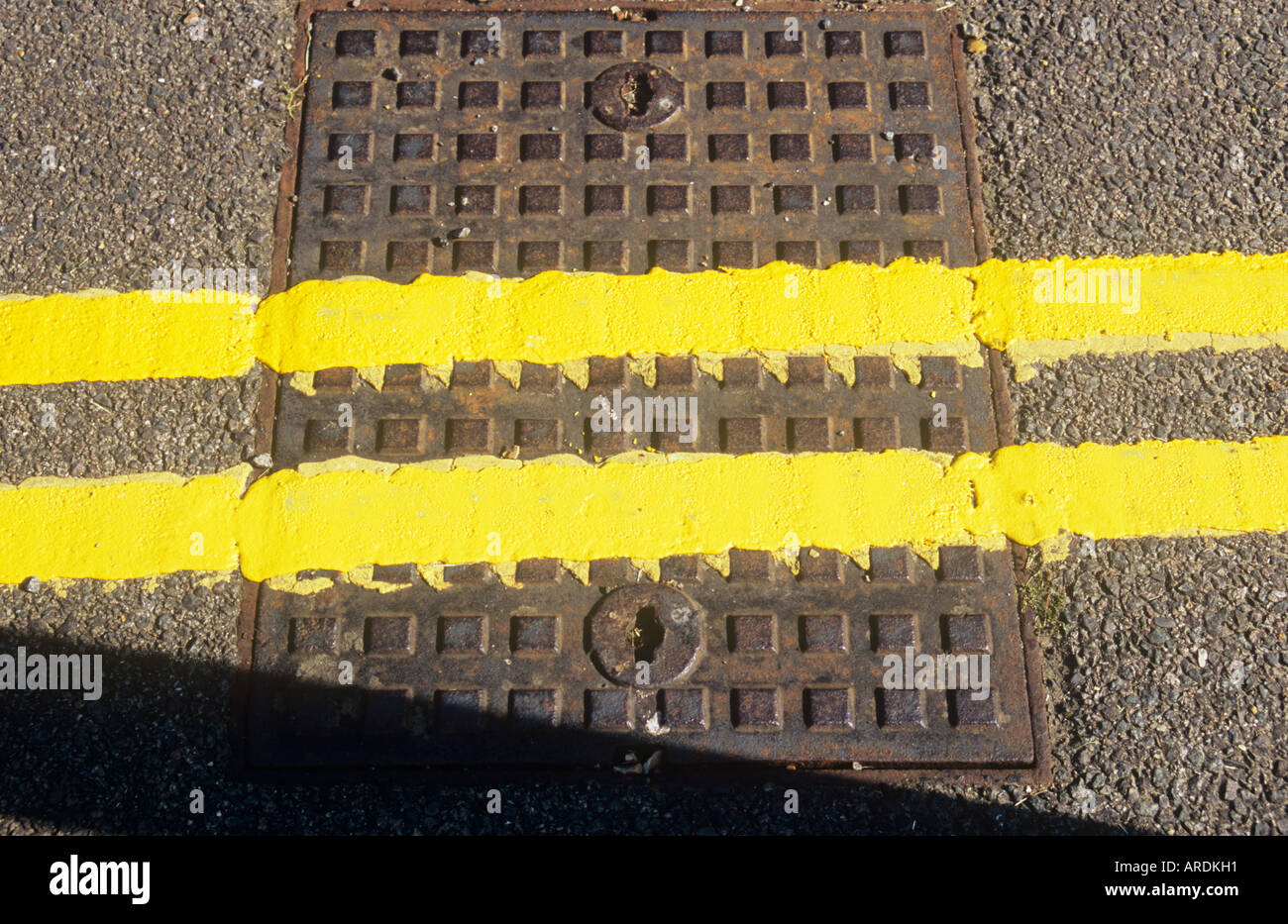 Detail from above of freshly painted double yellow lines crossing a ...