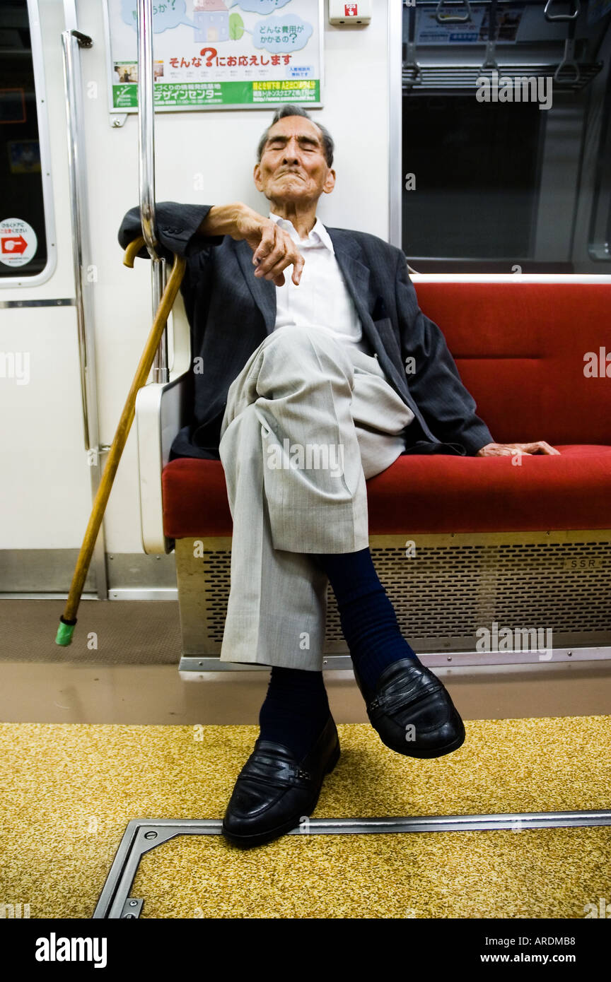 An old man naps on the Tokyo subway Stock Photo - Alamy